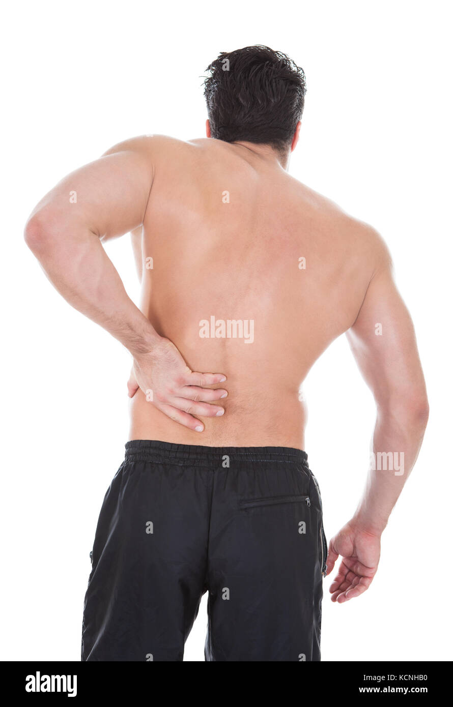 Rear View Of Young Man Suffering From Back Pain Stock Photo - Alamy