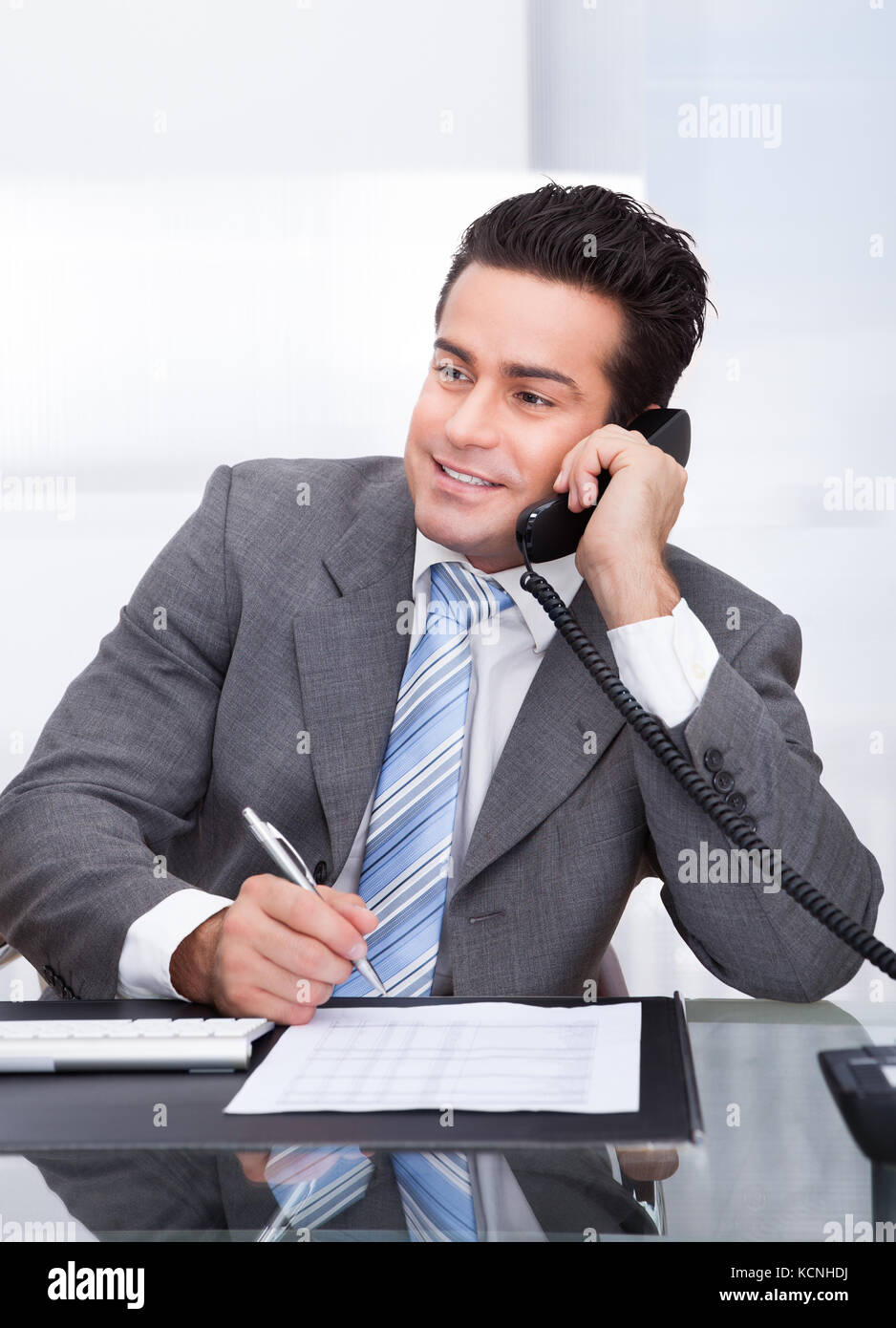 Young smiling businessman talking on phone hi-res stock photography and ...