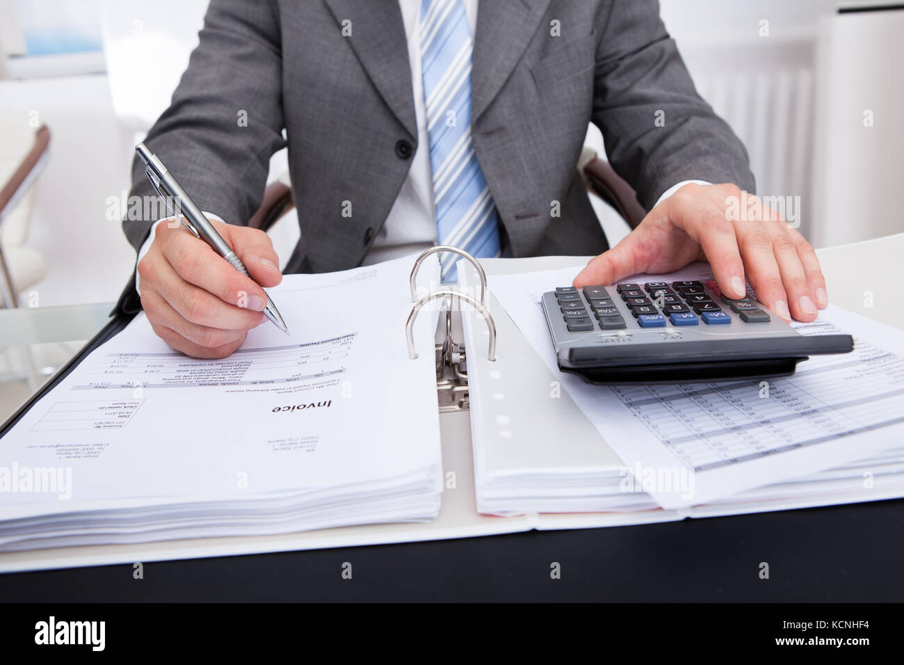 Close-up Of A Businessman Calculating Bills Using Calculator Stock ...