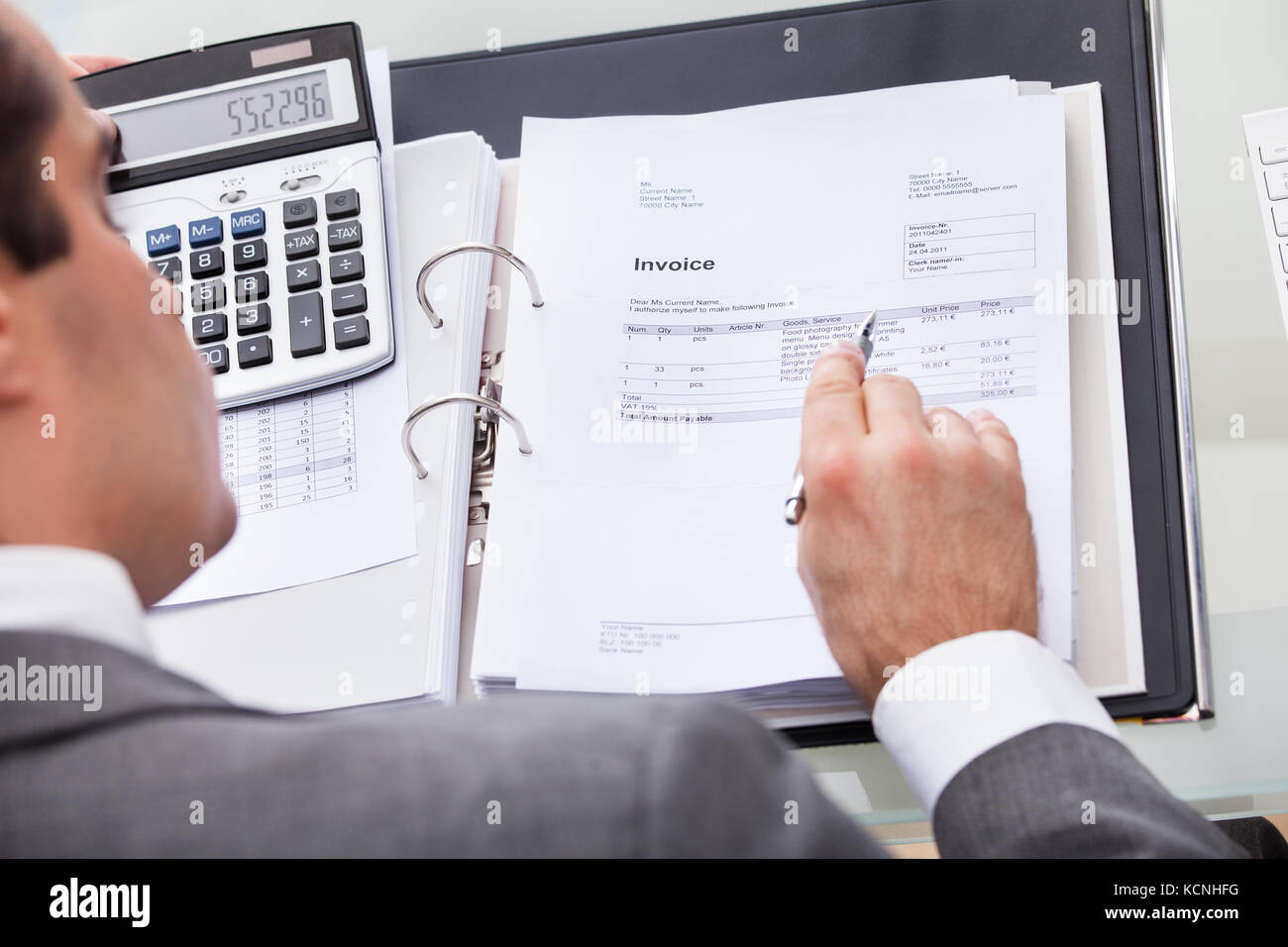 Businessman Calculating Documents Using Calculator In Office Stock ...