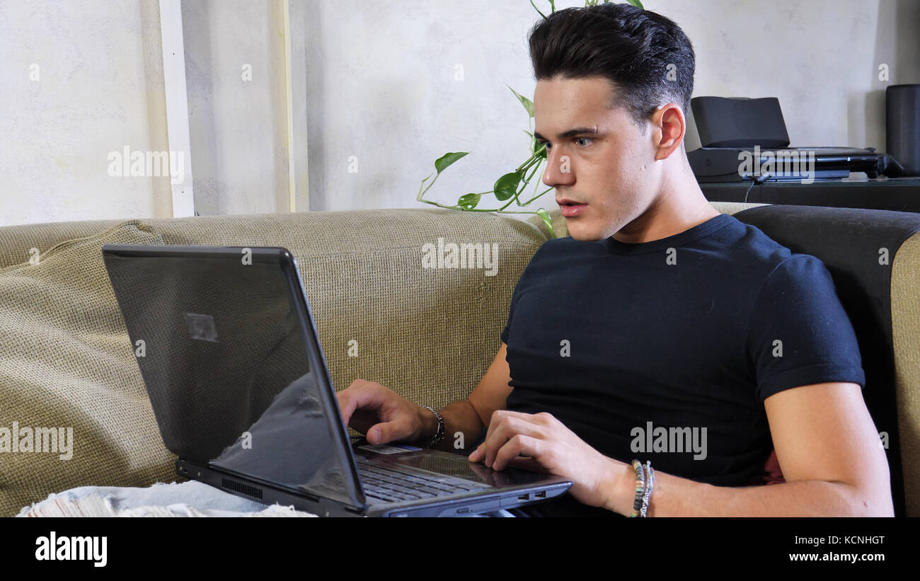 Preoccupied, worried man working on computer, alarmed Stock Photo - Alamy