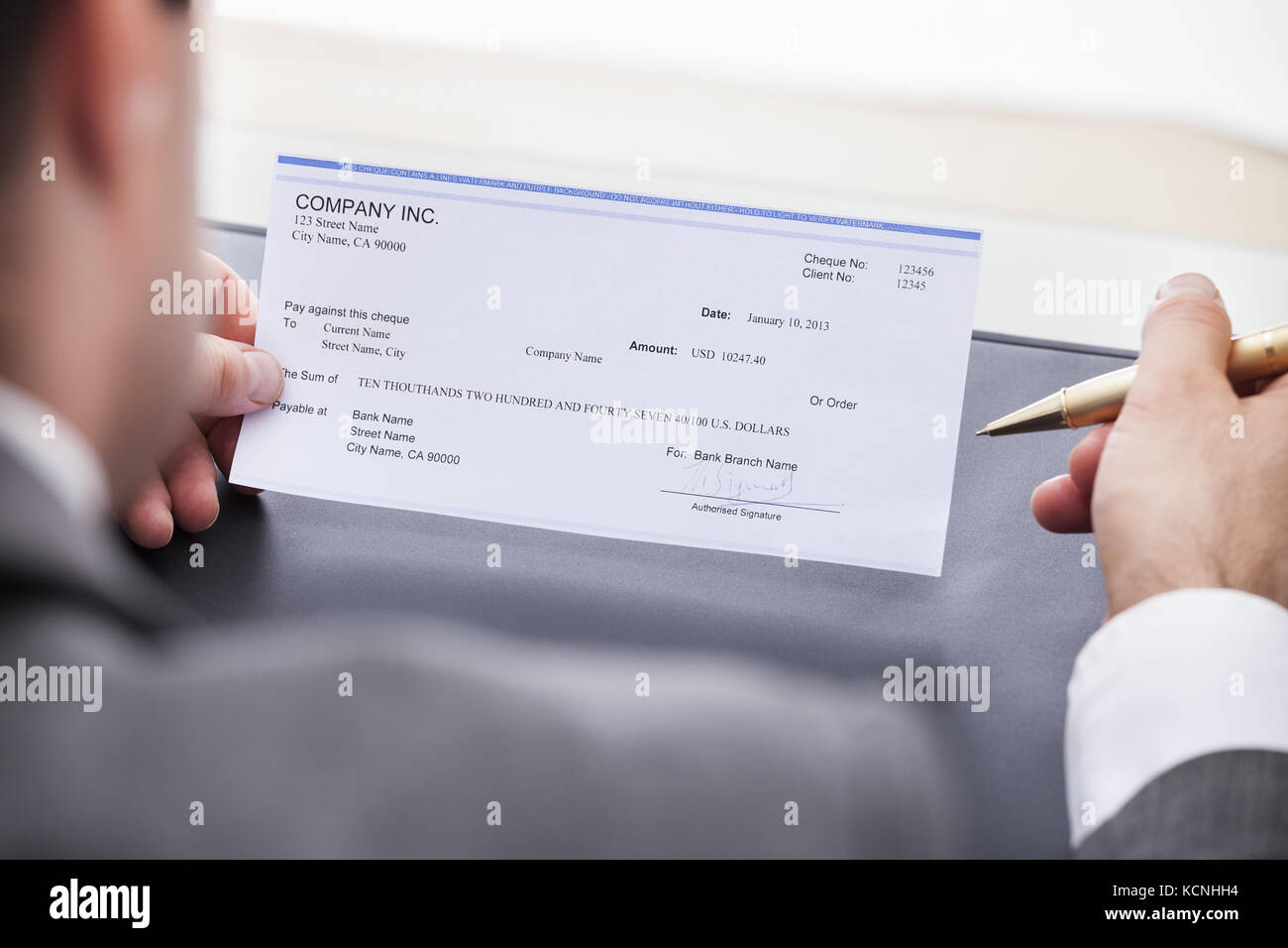 Close-up Of A Businessman Filling Blank Cheque Stock Photo - Alamy