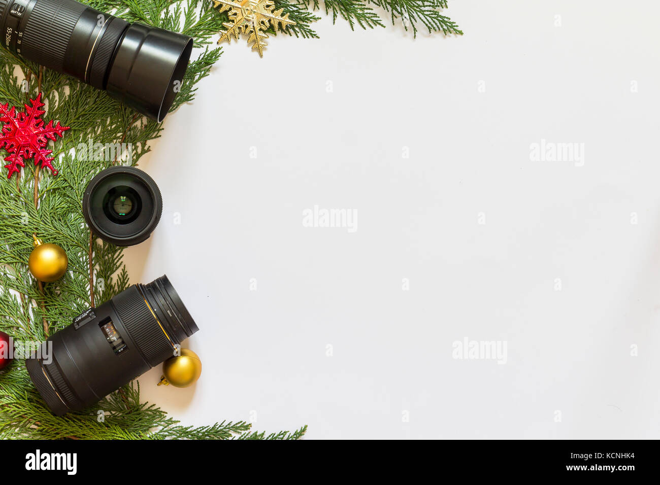 Lenses for reflex camera and Christmas decorations on a white ...