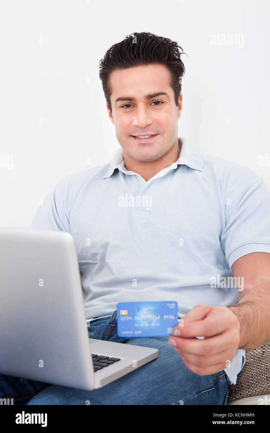 Happy Young Man Shopping Online Using Laptop And Credit Card Stock ...
