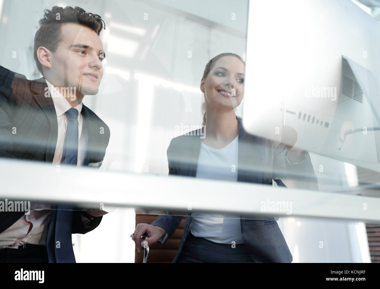 business concept.colleagues looking at computer screen Stock Photo - Alamy