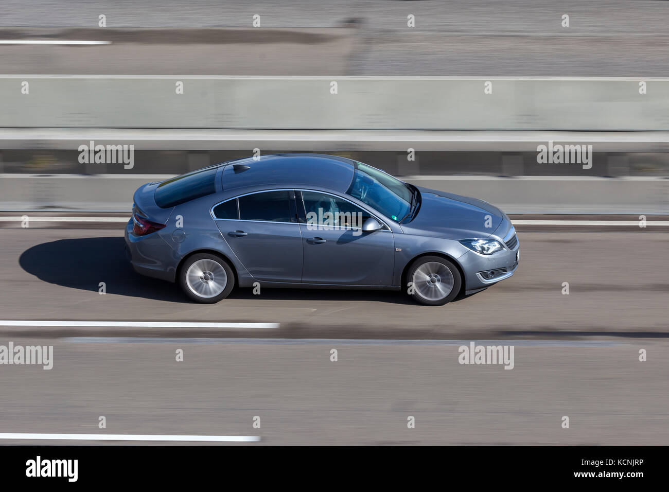 Compact car driving fast on the highway Stock Photo - Alamy