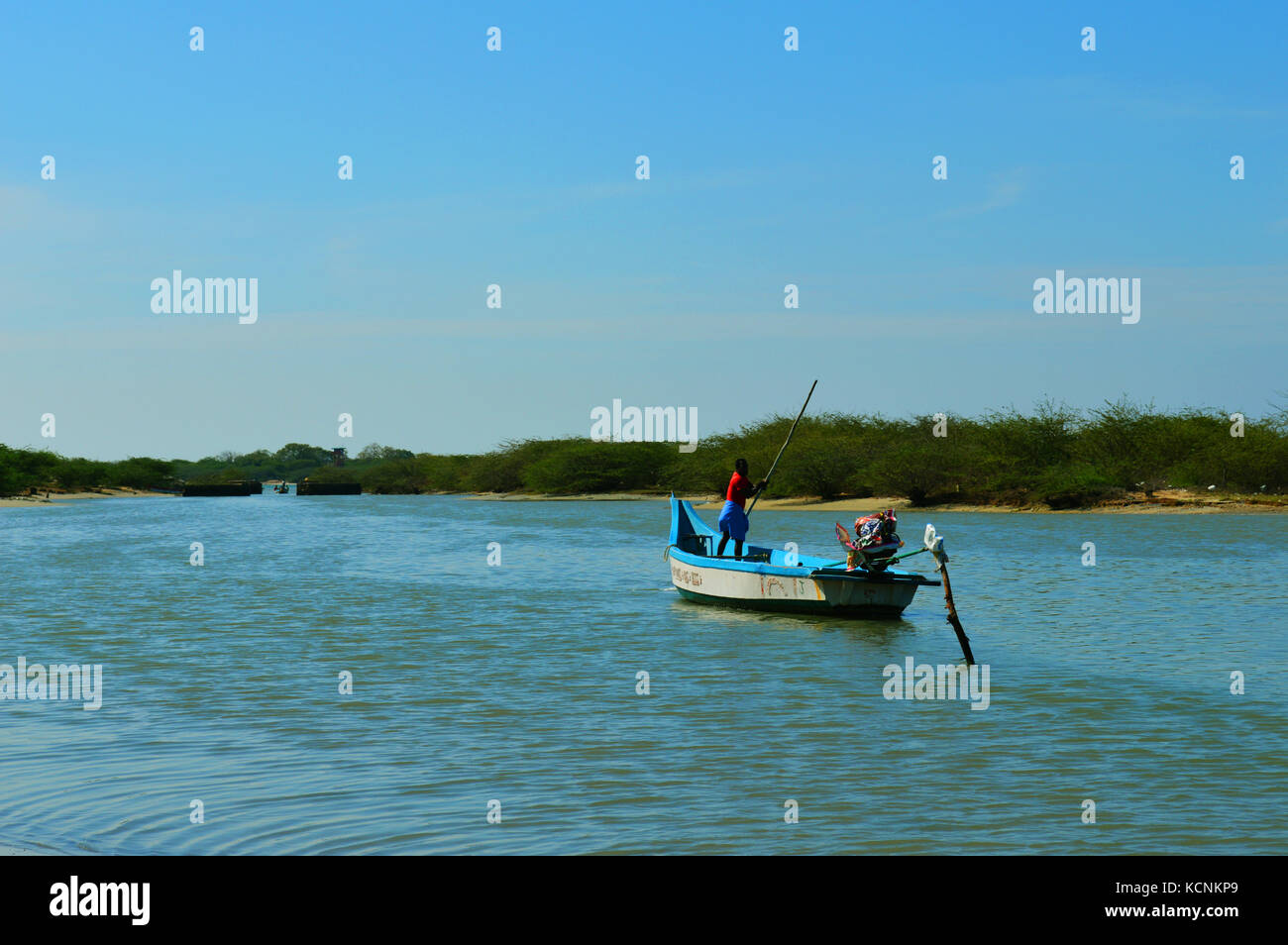 A fisherman with net in a boat Stock Photo - Alamy