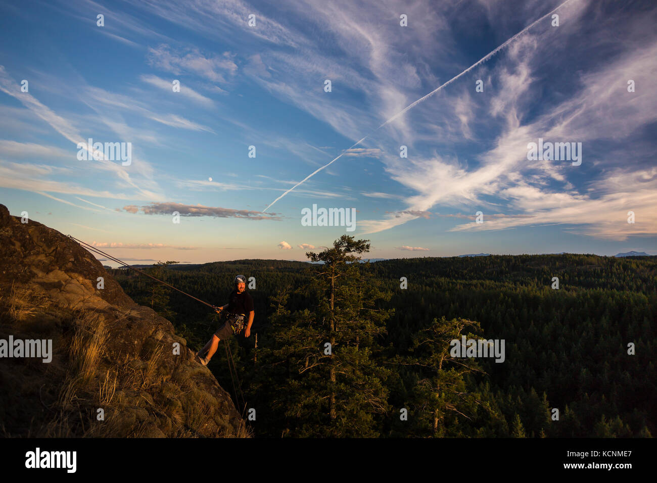 A climber rappels down sunset slab after completing a climb on one of ...