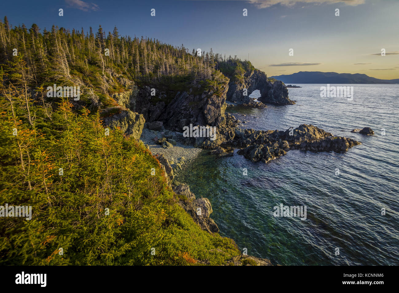 Sunset with a natural bridge in view along a coastal area of Green Bay ...