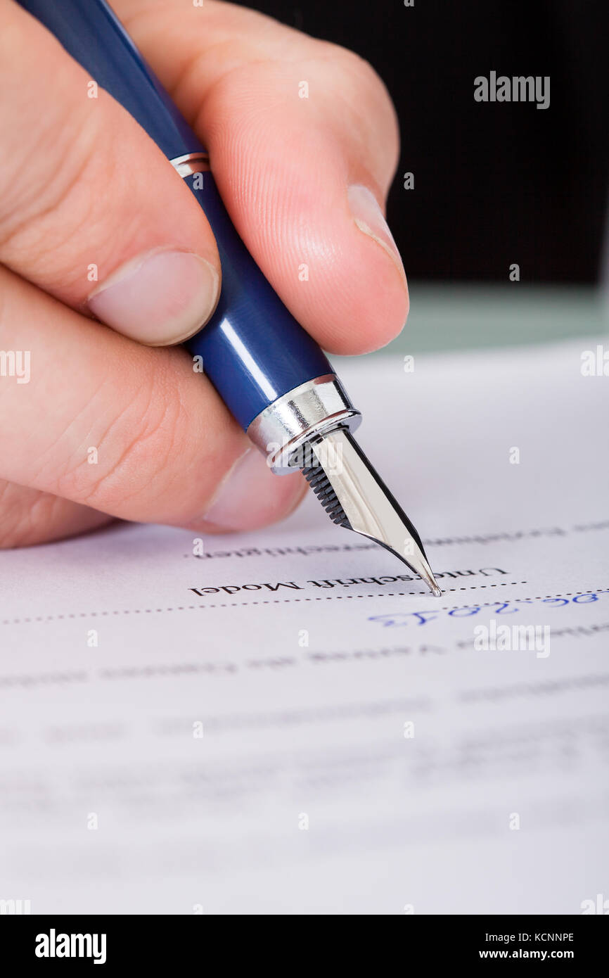 Close-up Of Businessman Hand Writing With Ink Pen Over Document Stock ...