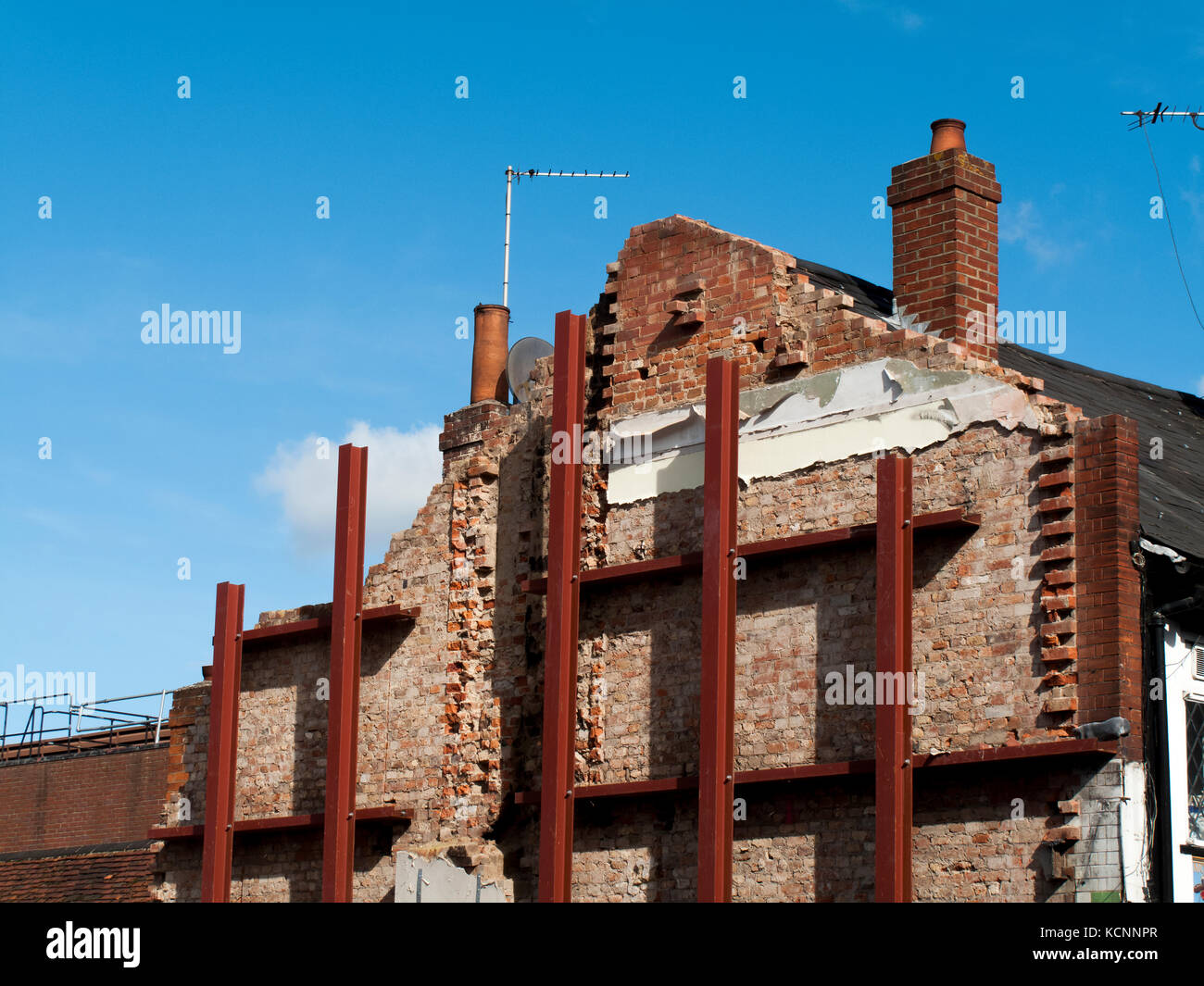 Building shored up with steelwork due to demolition and redevelopment ...