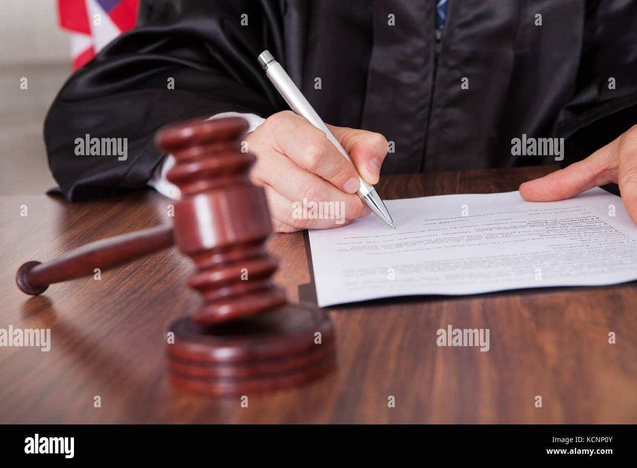 Close-up Of Male Judge Writing On Paper In Courtroom Stock Photo - Alamy