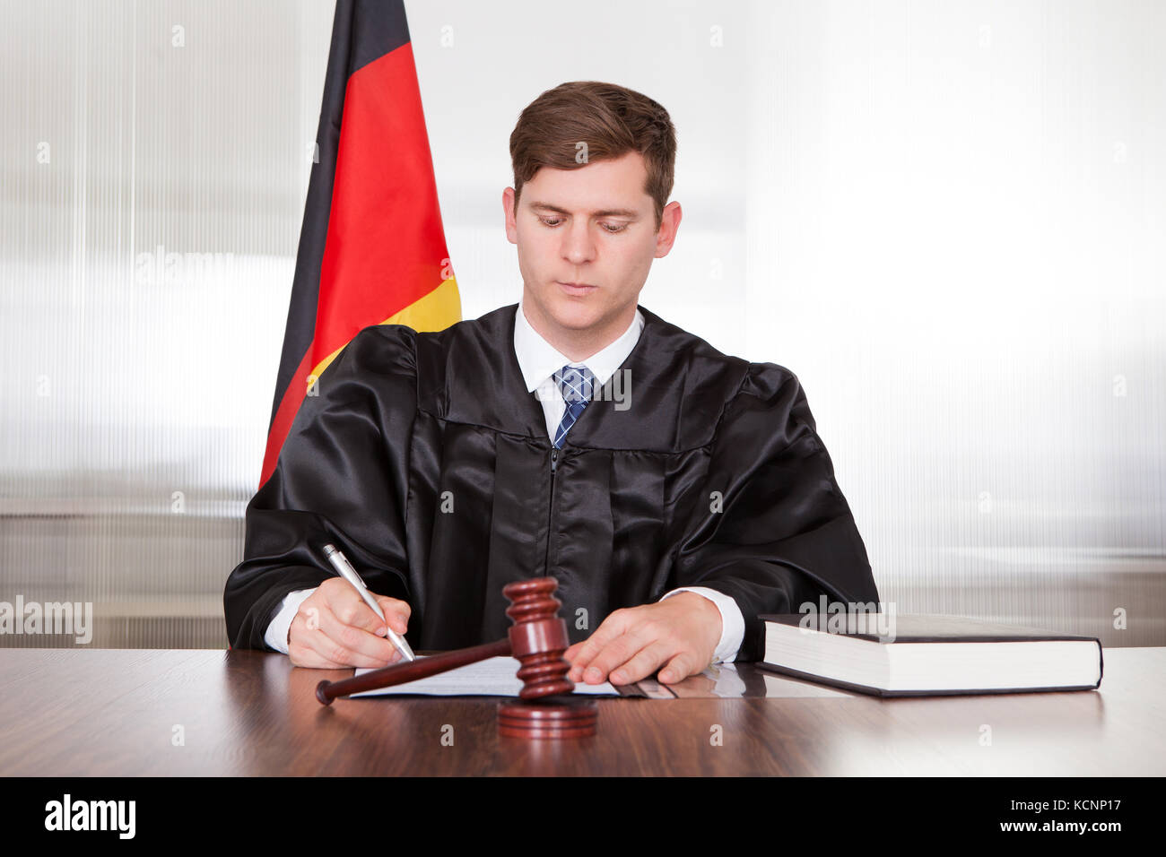Male Judge With The Gavel And Book In Courtroom Stock Photo - Alamy
