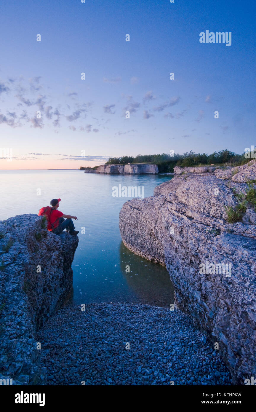 hiker on limestone cliffs, Steep Rock, along Lake Manitoba, Manitoba ...