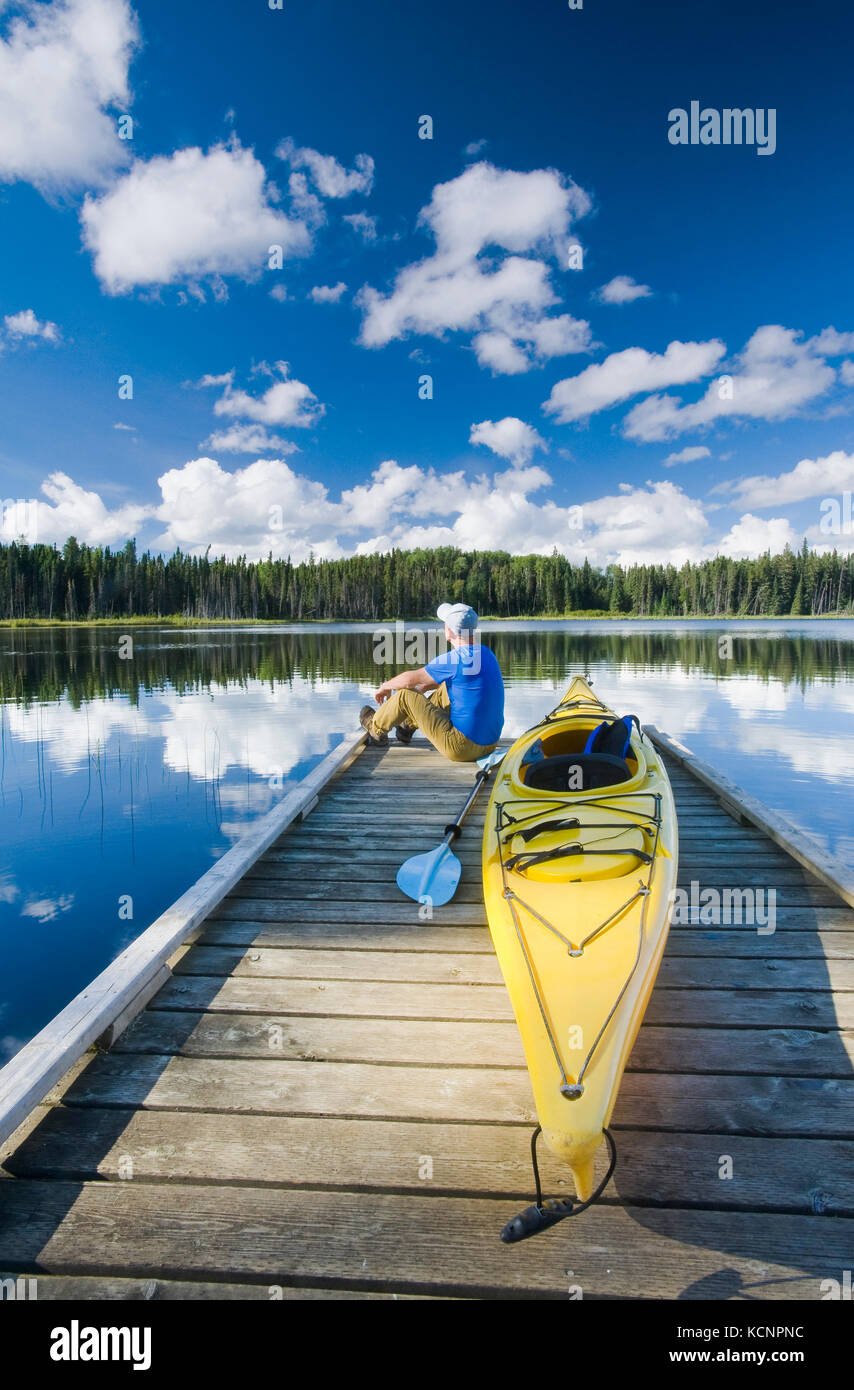 Man sitting on dock hi-res stock photography and images - Alamy