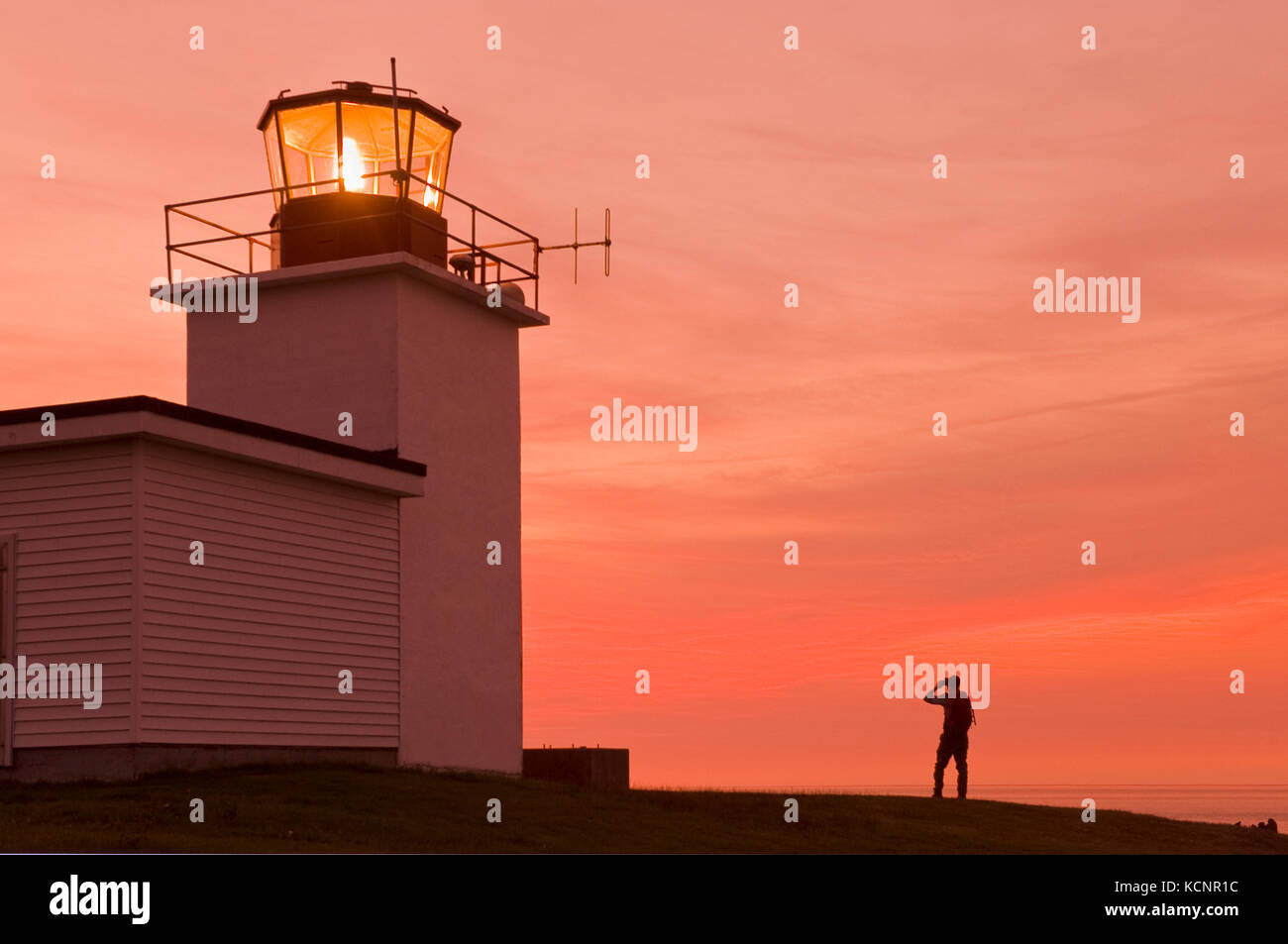 Hiker looking out over grand passage lighthouse hi-res stock ...