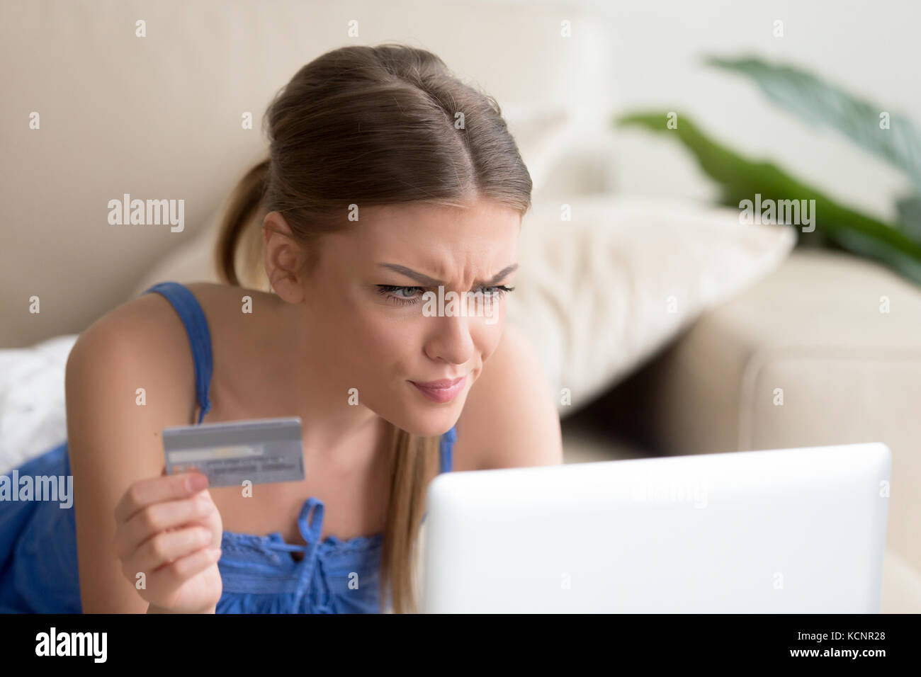 Confused young woman having problem with blocked credit card making ...