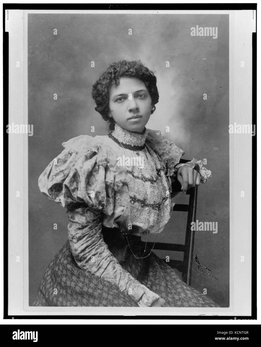 African American woman, three quarter length portrait, seated with left ...