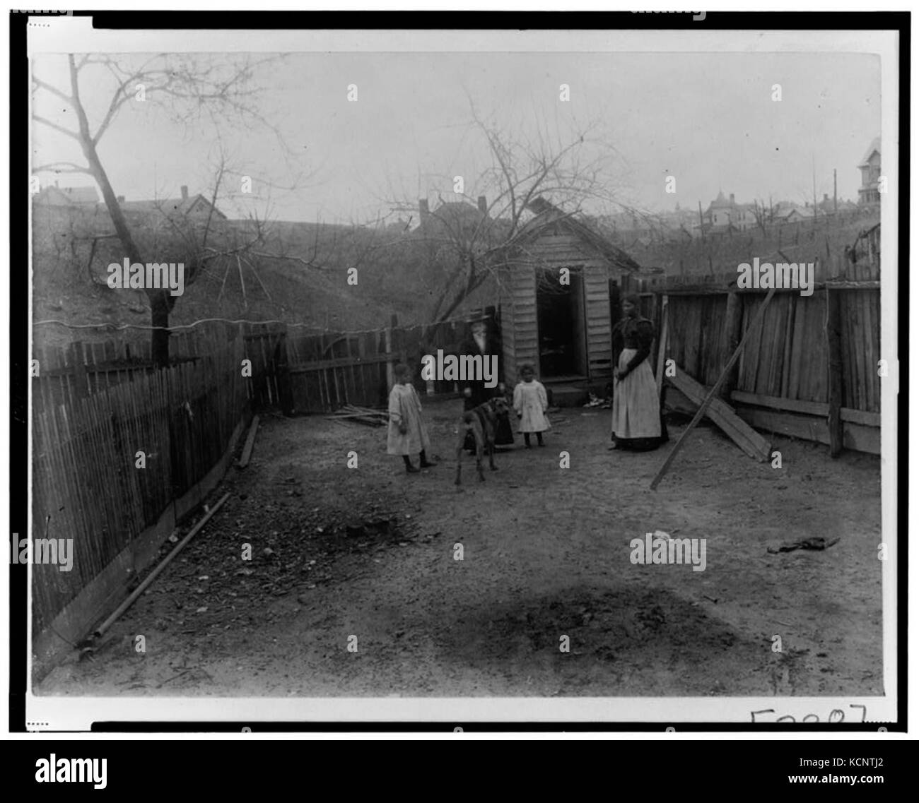 This photograph features an African American family standing in their ...
