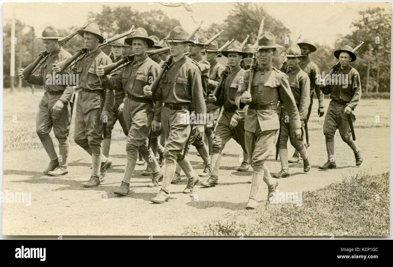Group of Soldiers Marching on a Dirt Path Through a Grass Field Stock ...