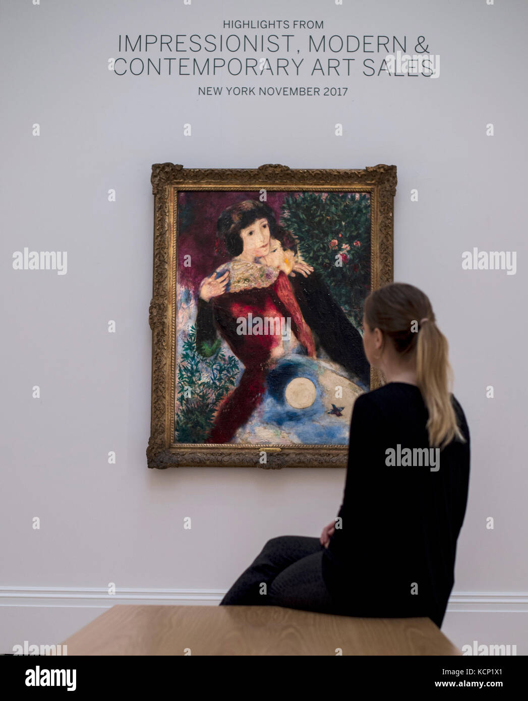 A Sotheby's employee looks at Marc Chagall's Les Amoureux, 1928, during ...