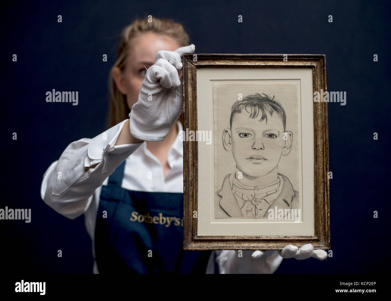 Sotheby's employees hold Lucian Freud's Boy on the Stairs, 1948, during ...