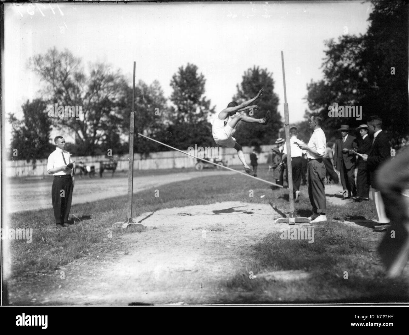 A historical photograph of a high school track meet in 1912, capturing ...
