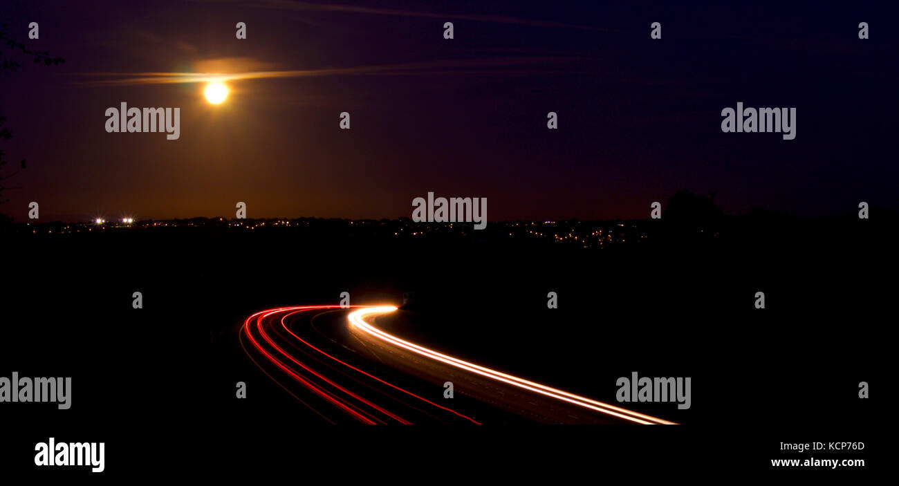 Light trails on a clear evening in October, under a harvest moon Stock ...
