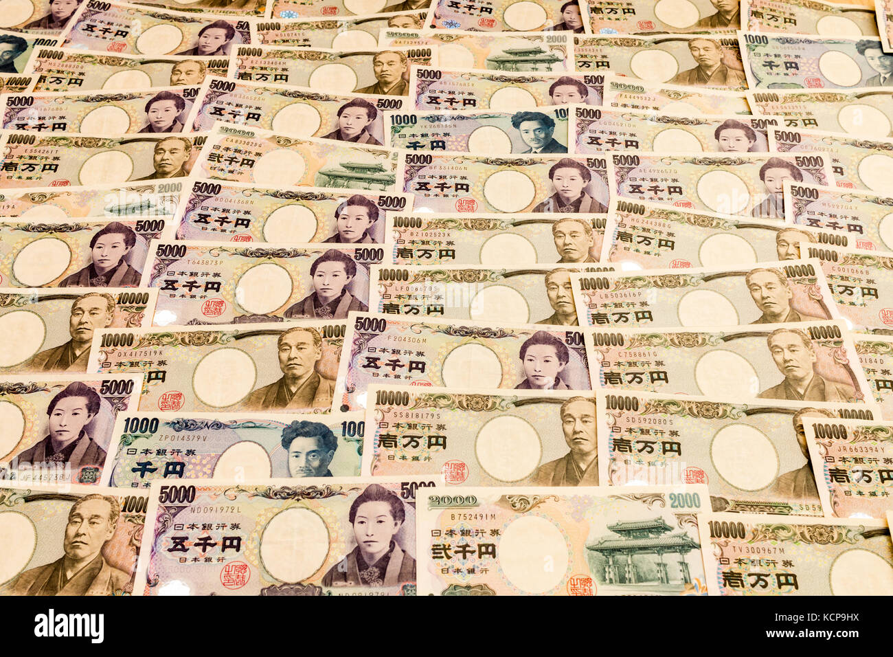 Japanese banknotes of various amounts laid out forming background Stock ...