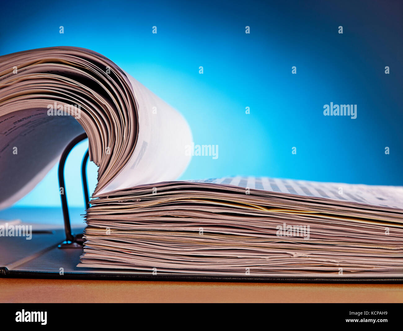 Detail of an open file folder on a blue background Stock Photo - Alamy