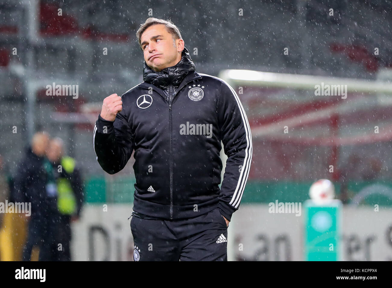 German head coach Stefan Kuntz arriving to the field under the rain ...