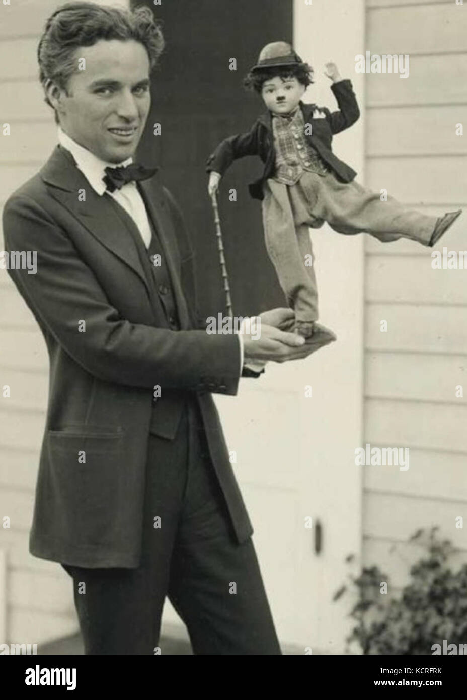 Charlie Chaplin with doll Stock Photo - Alamy