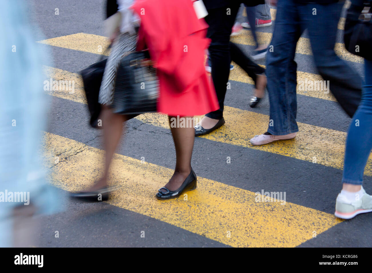 Blurry legs of people walking on zebra crossing on city street Stock ...