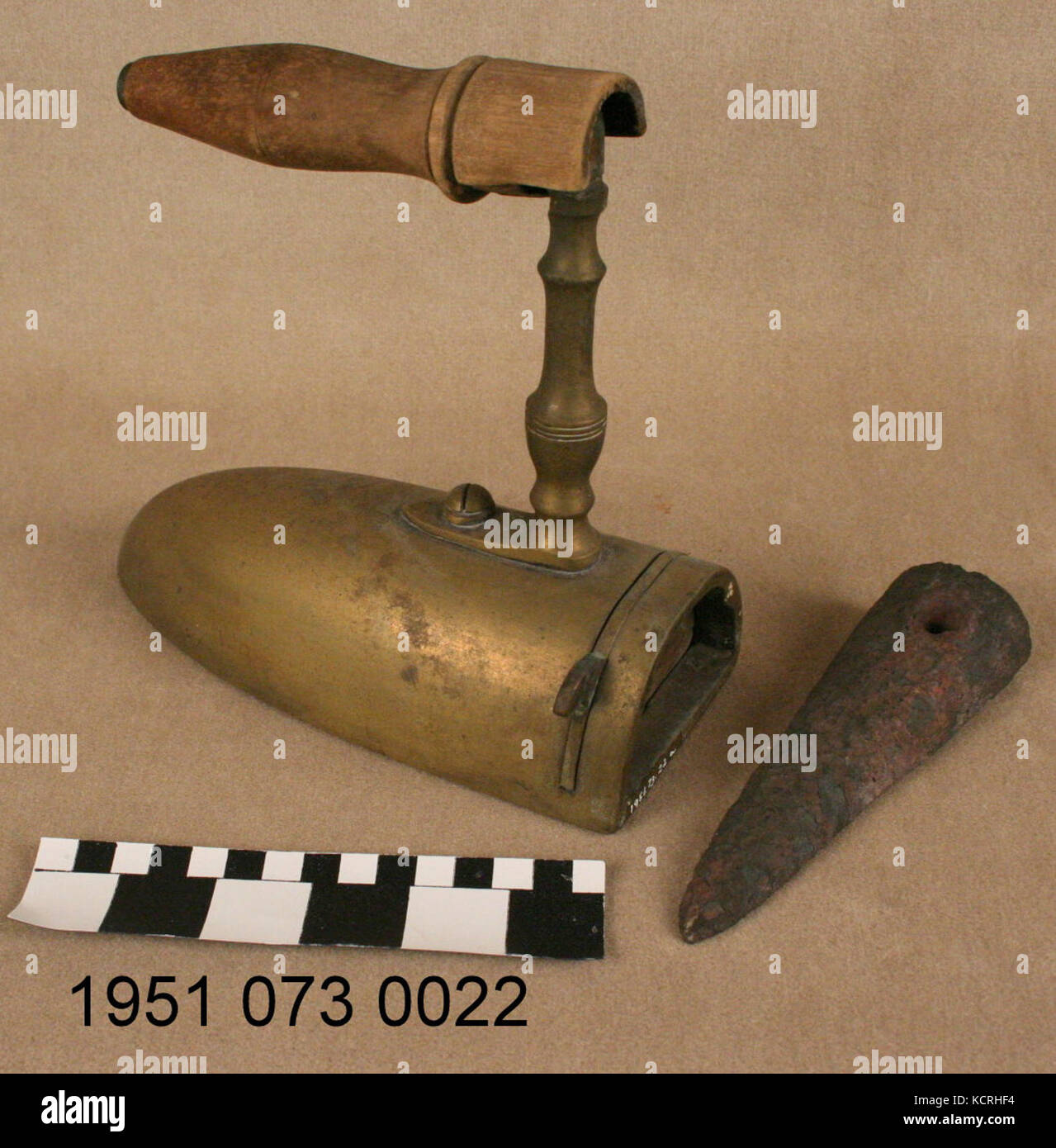 Brass sadiron, single handle, slug heated Stock Photo - Alamy