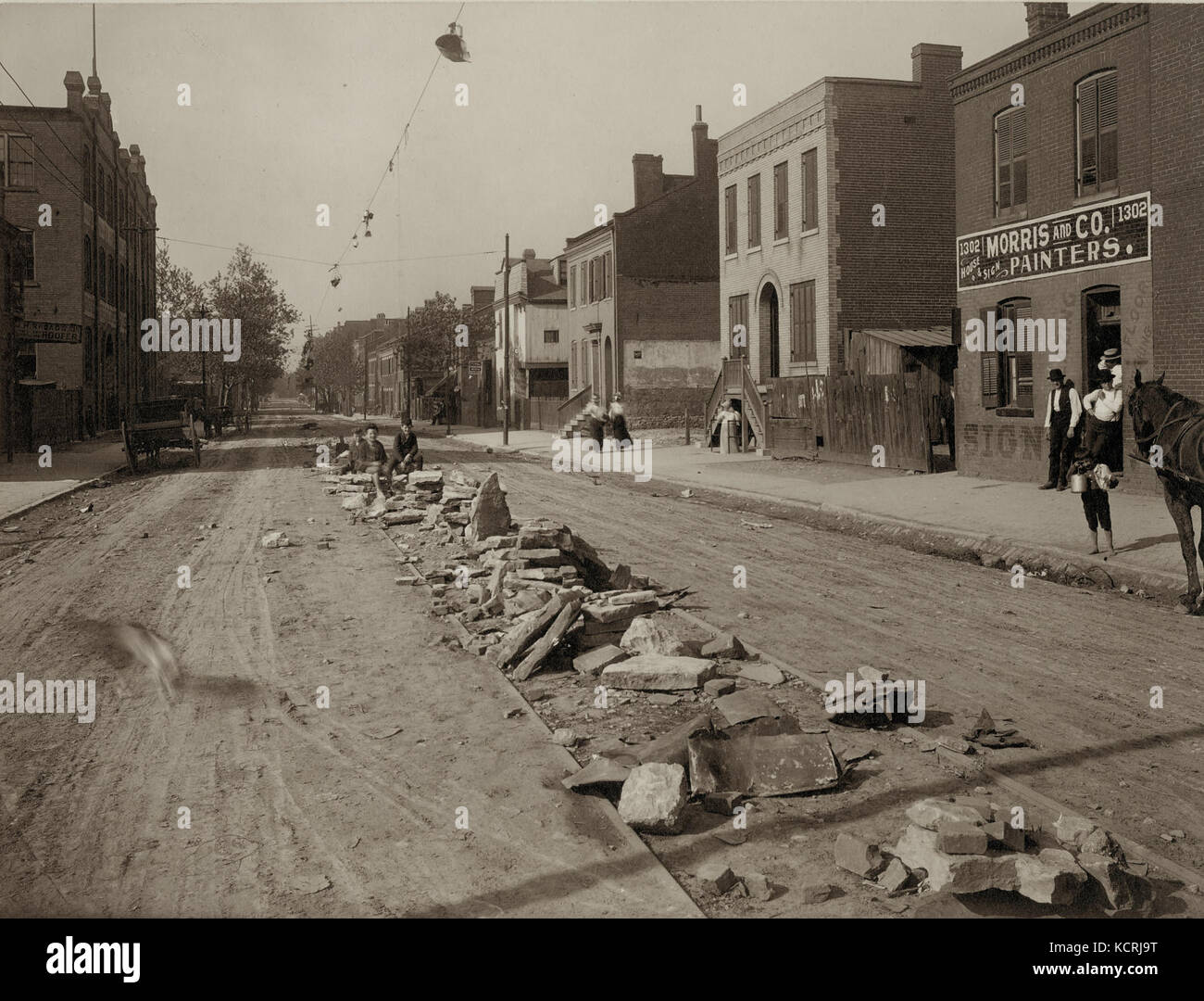Children pose on rocks and stones piled on tracks during streetcar ...