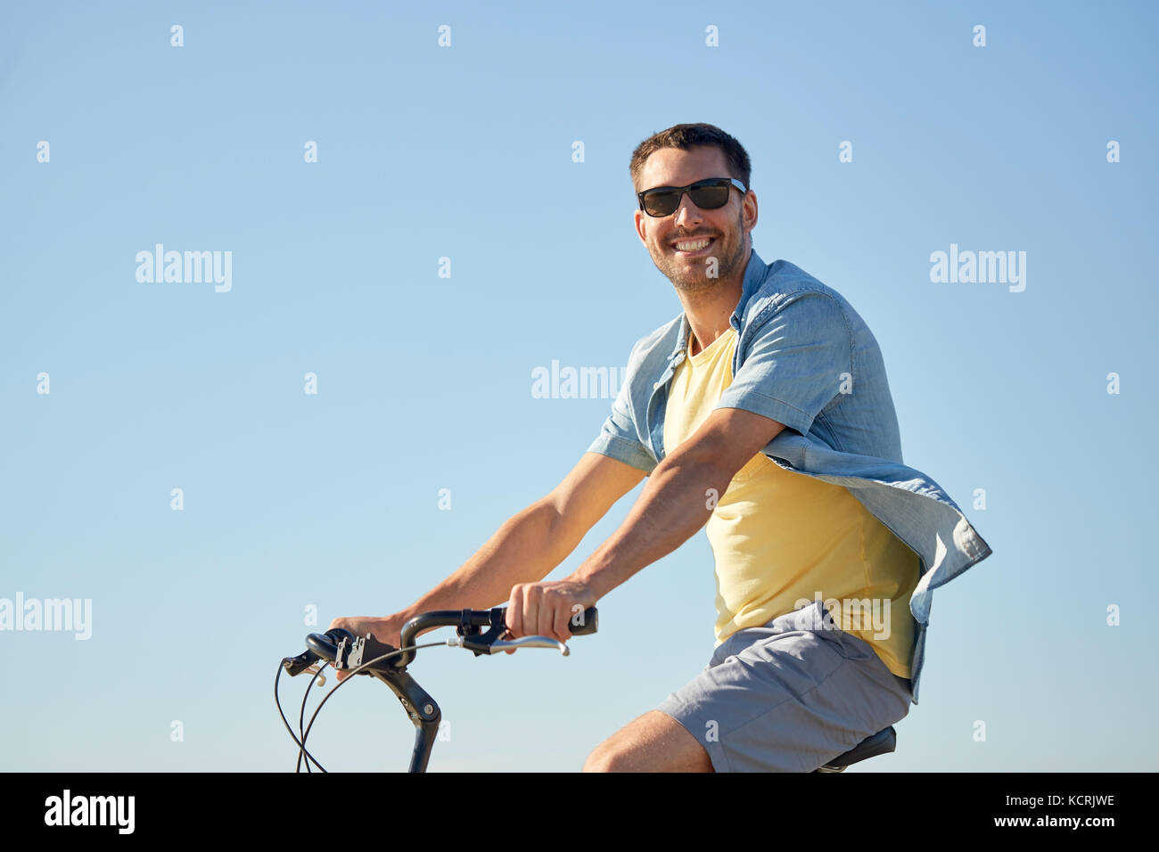 happy smiling man riding bicycle outdoors Stock Photo - Alamy