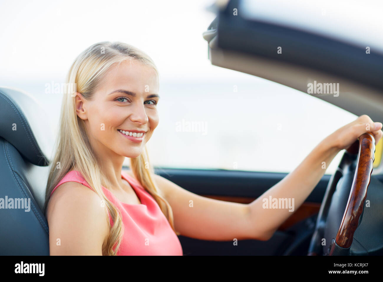 happy young woman driving convertible car Stock Photo - Alamy