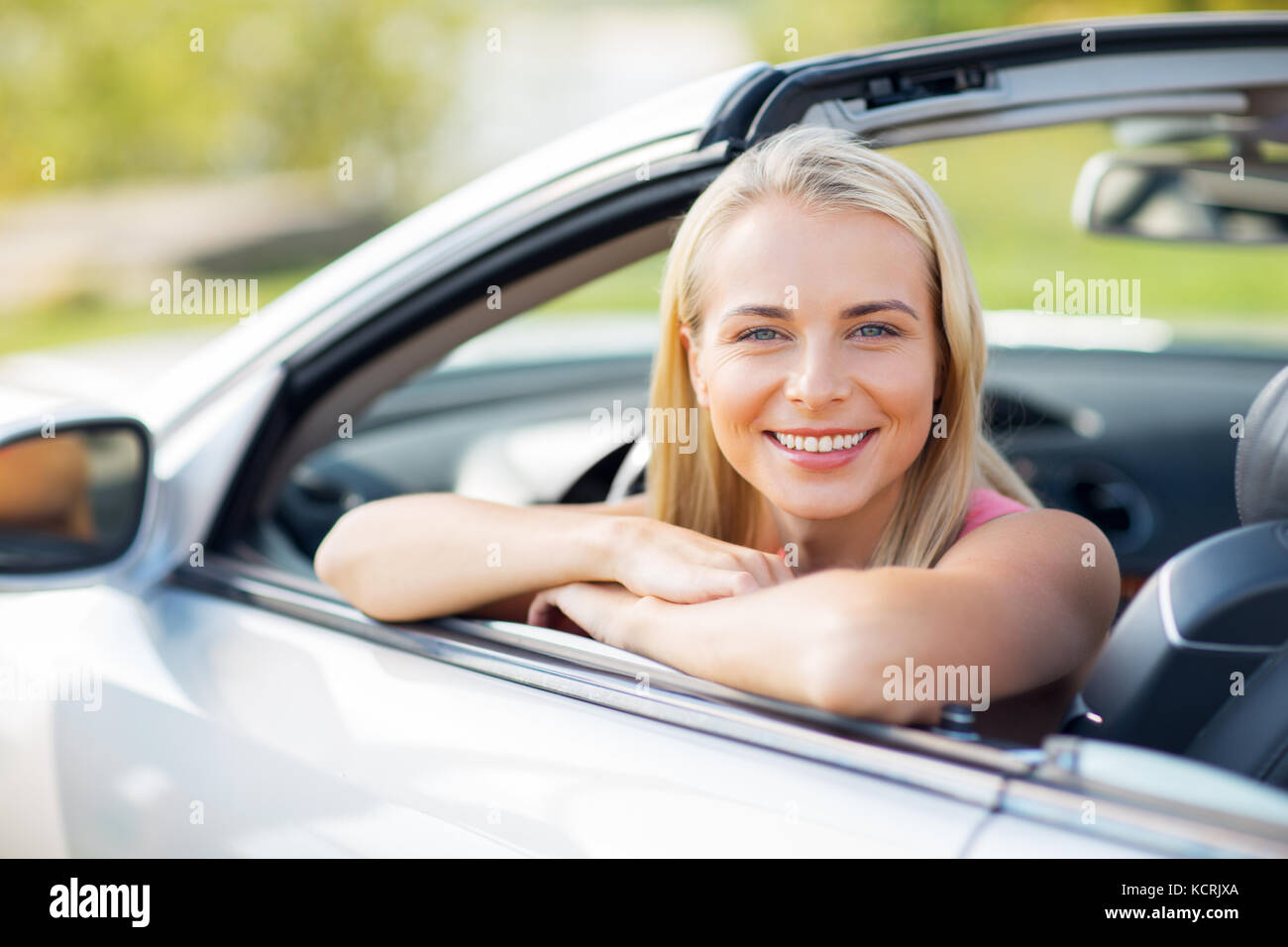 happy young woman in convertible car Stock Photo - Alamy
