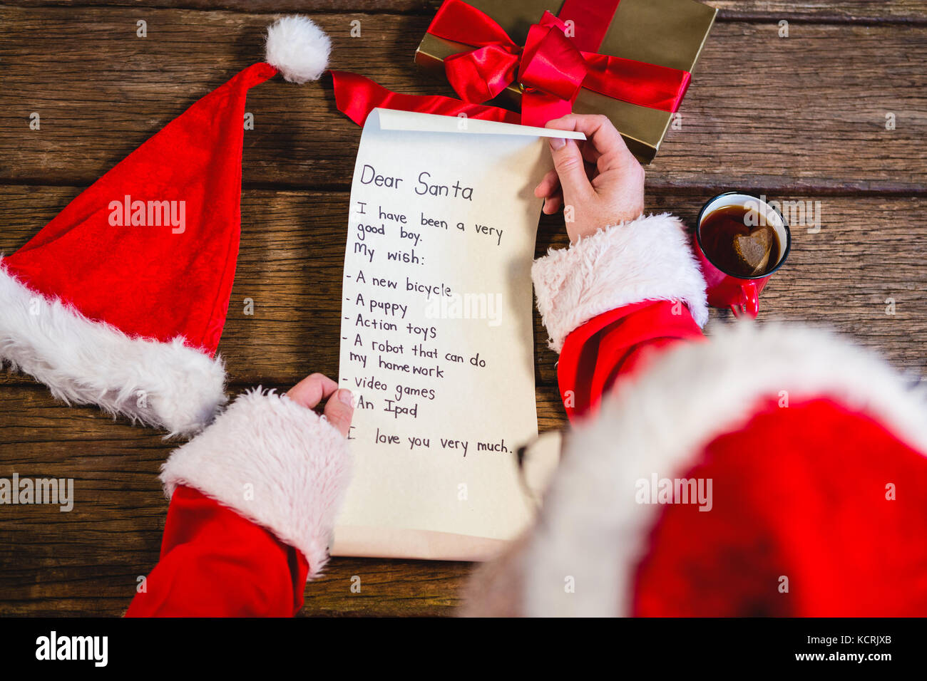Close-up of Santa Claus reading scroll Stock Photo - Alamy