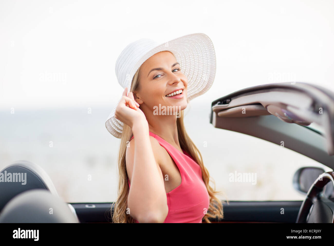 happy young woman in convertible car Stock Photo - Alamy