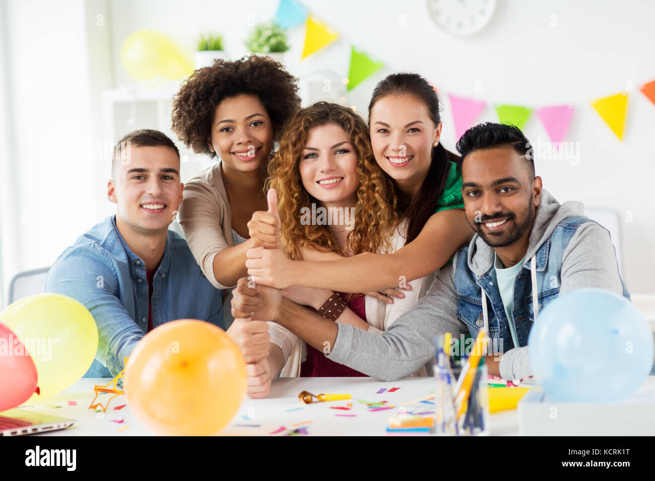 happy team at office party showing thumbs up Stock Photo - Alamy