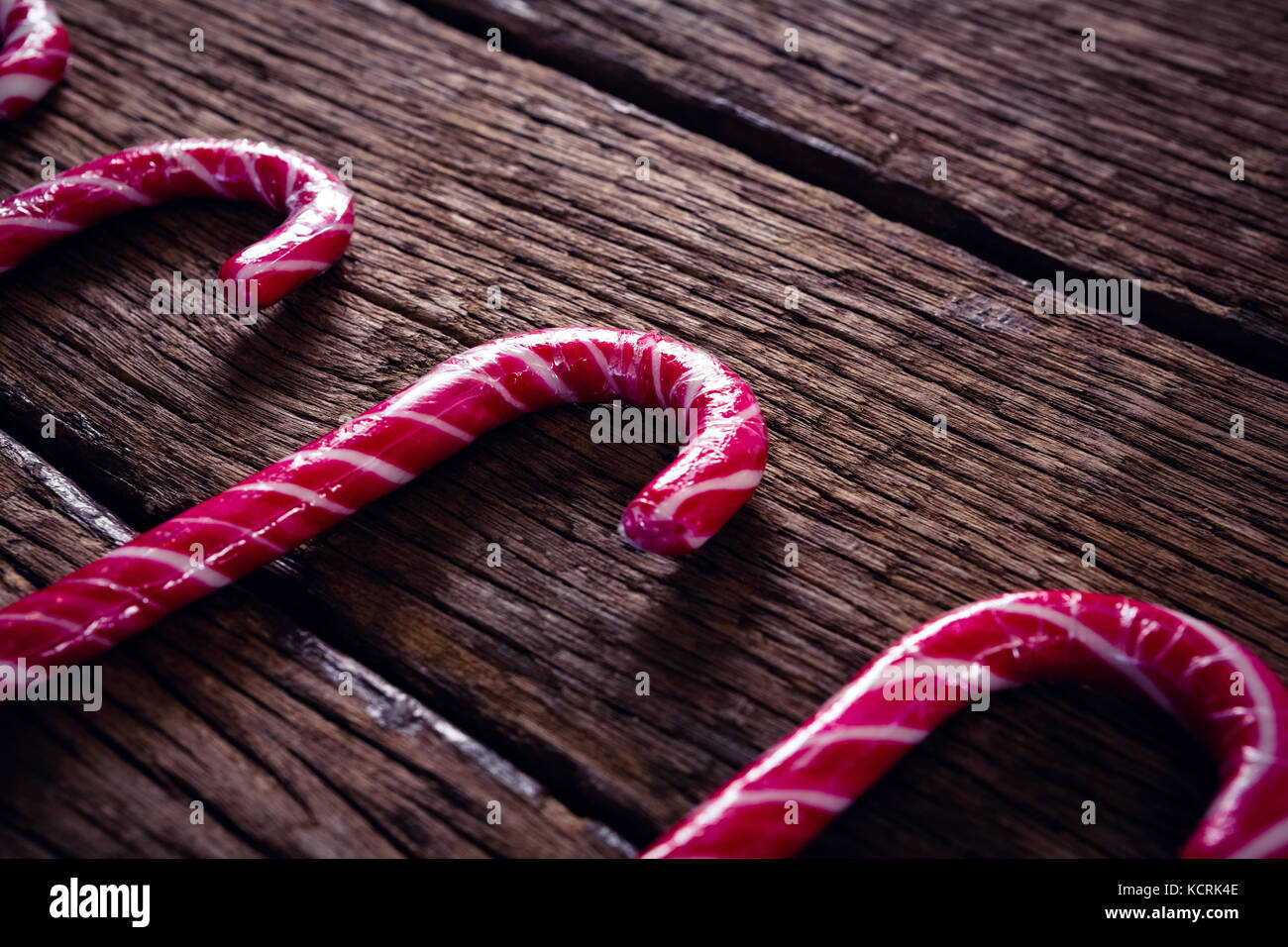 Close-up of pink candy canes arranged on wooden plank Stock Photo - Alamy