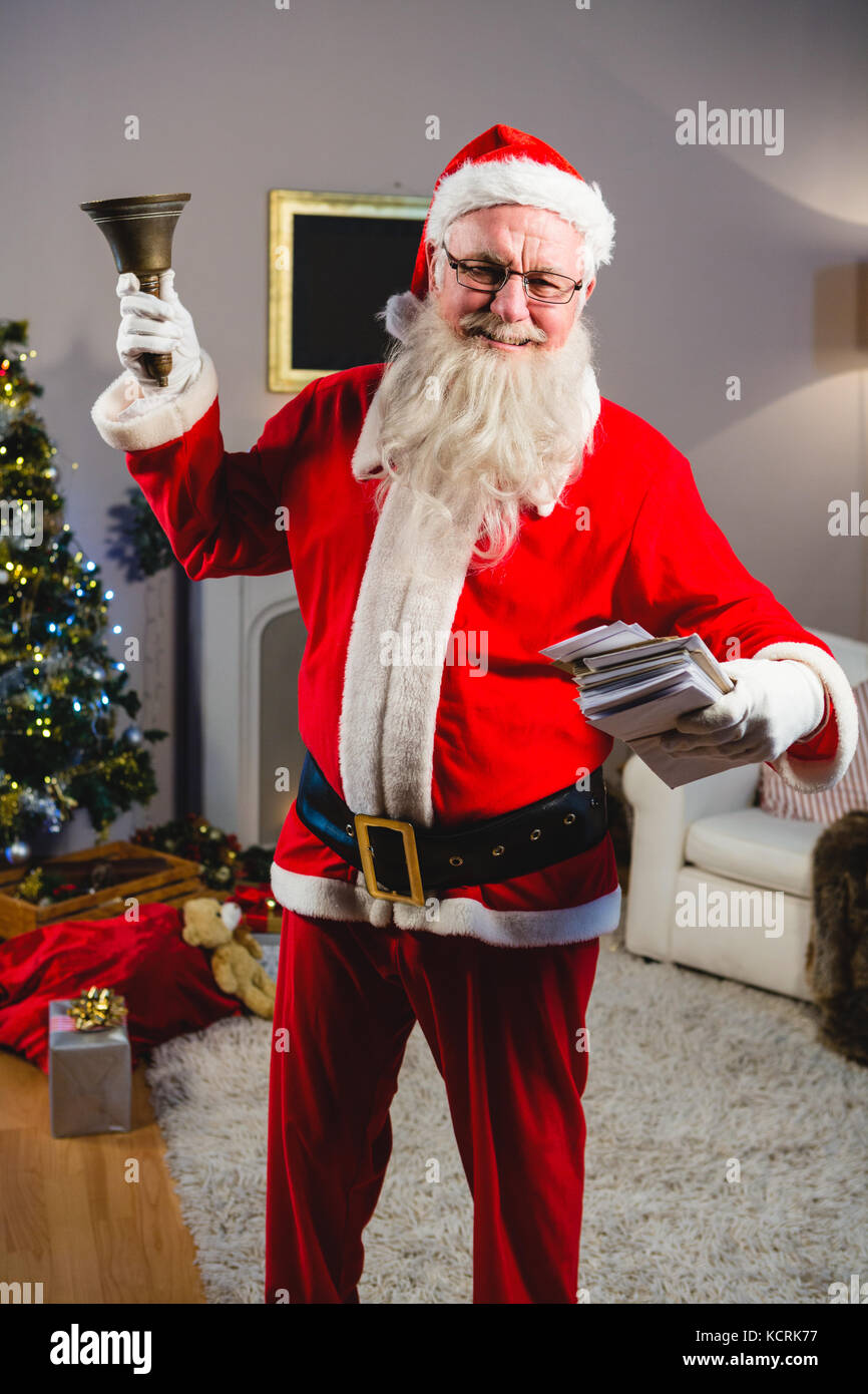 Portrait of santa claus ringing a bell at home during christmas time ...