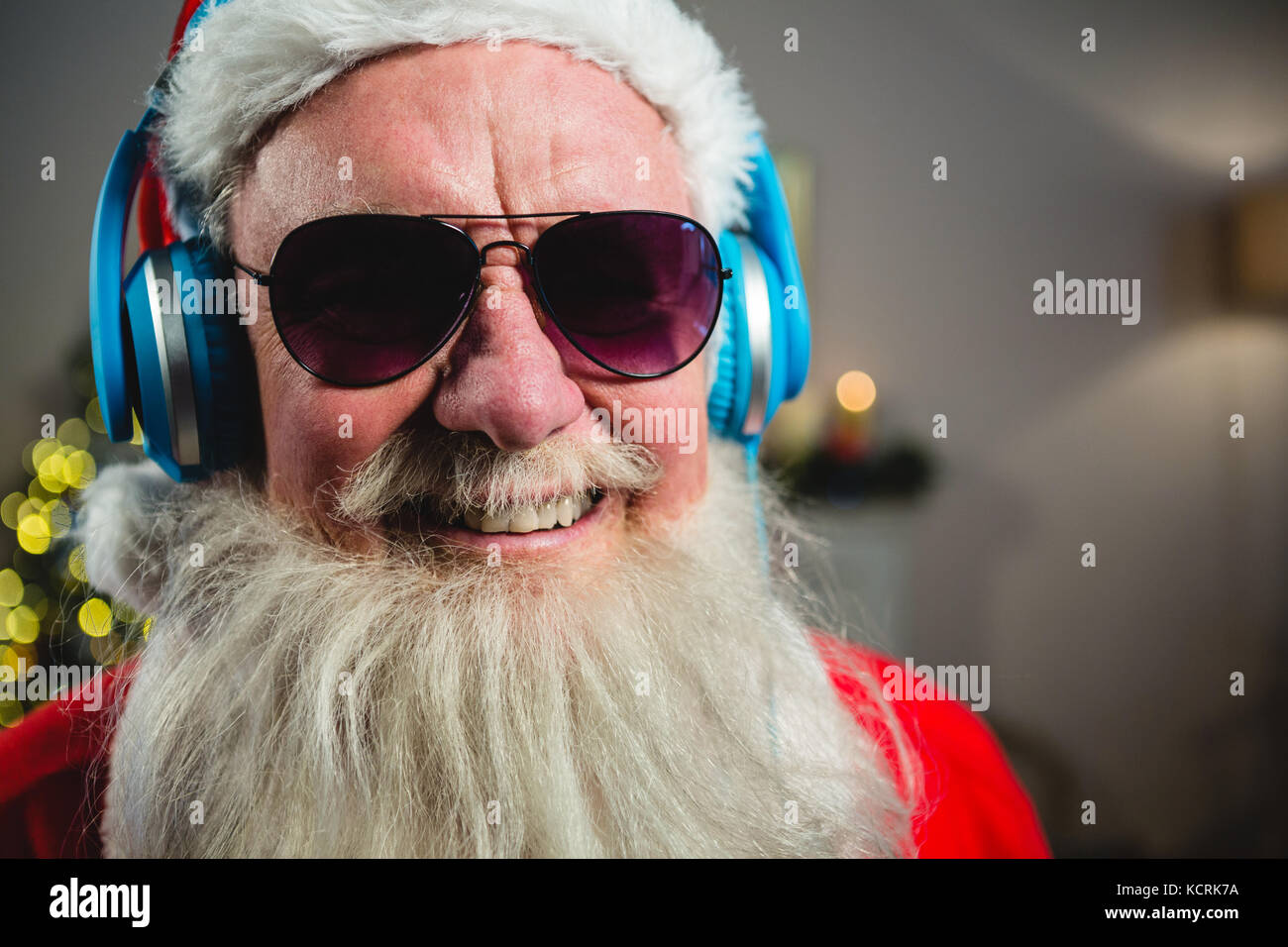 Santa Claus listening to music on headphones at home Stock Photo - Alamy