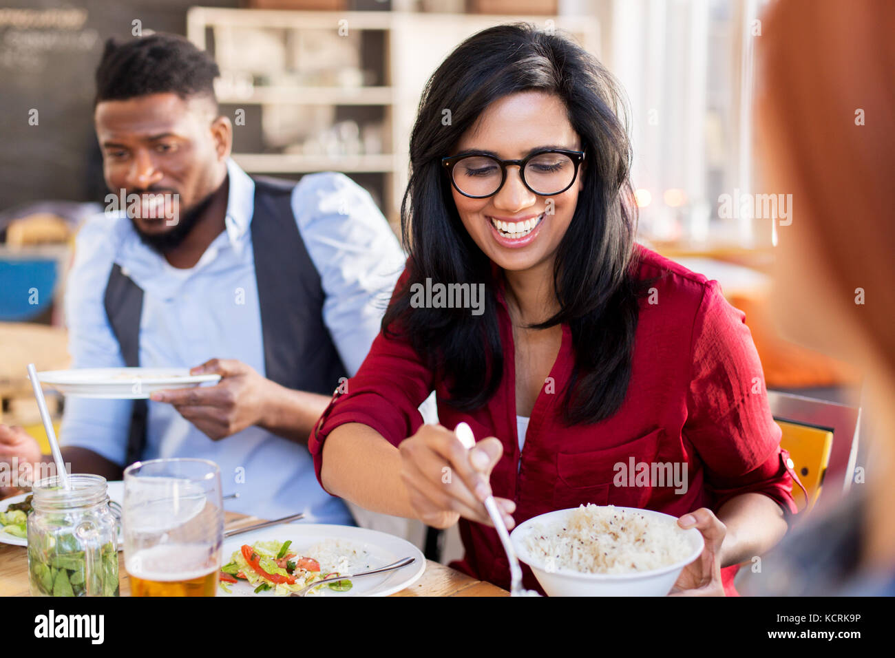 happy friends eating at restaurant Stock Photo - Alamy