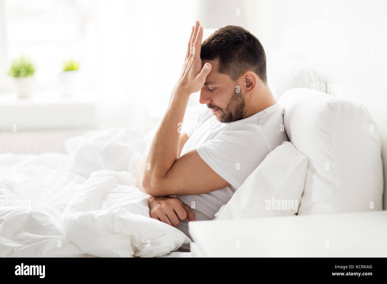stressed man in bed at home Stock Photo - Alamy