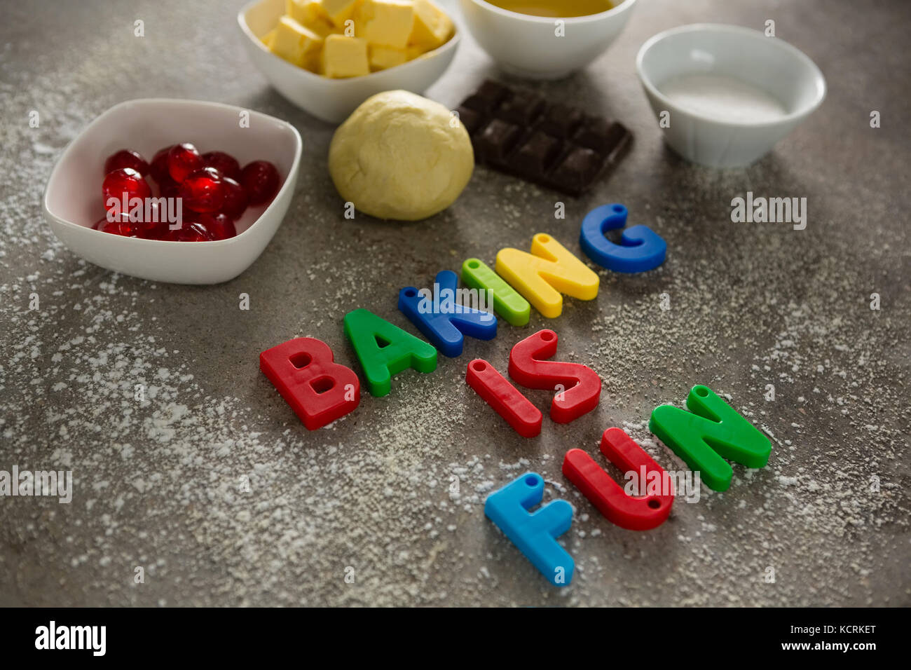 Various baking ingredients and alphabet forming baking is fun on table ...