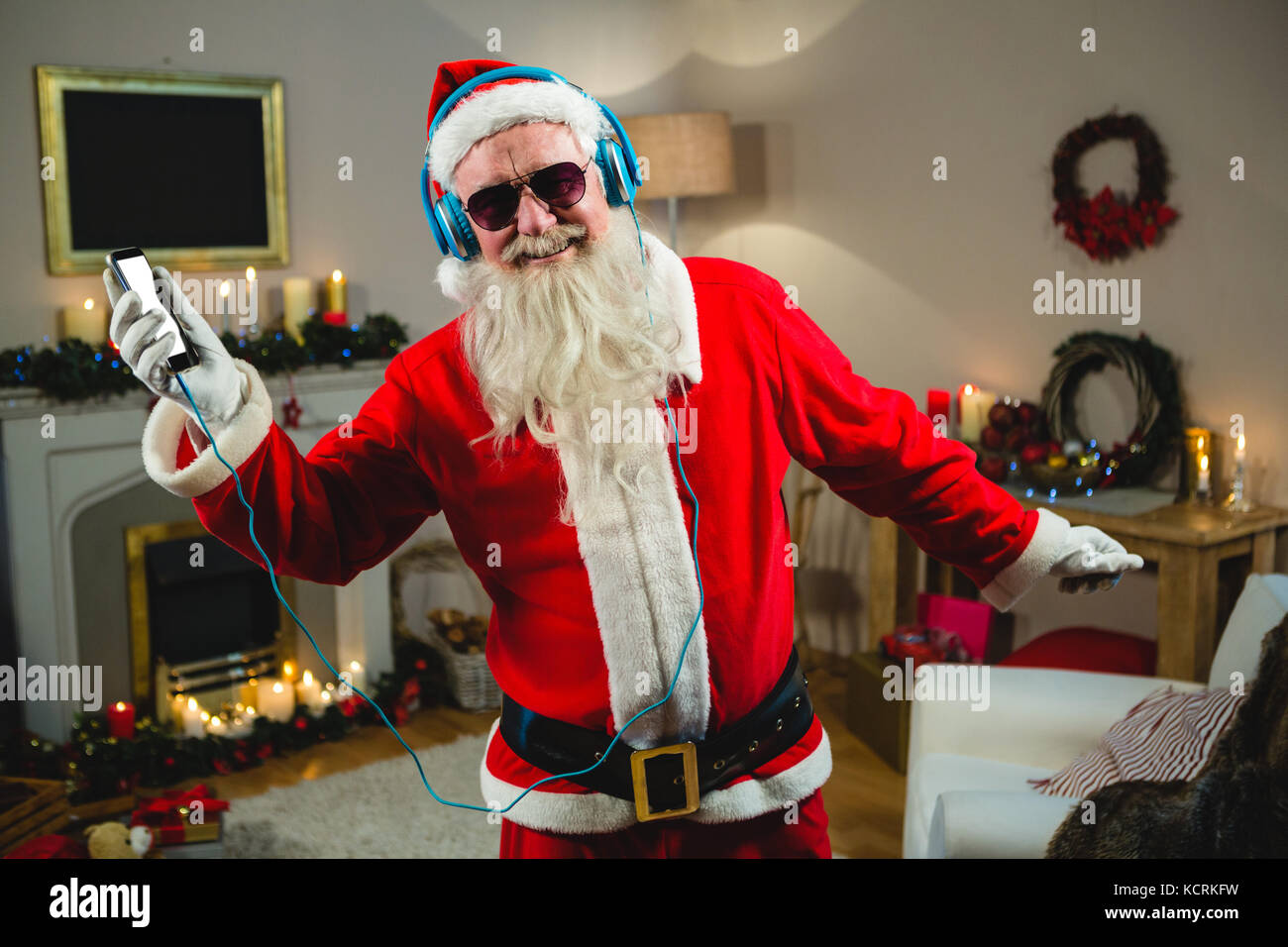 Smiling of santa claus singing a christmas songs at home during ...