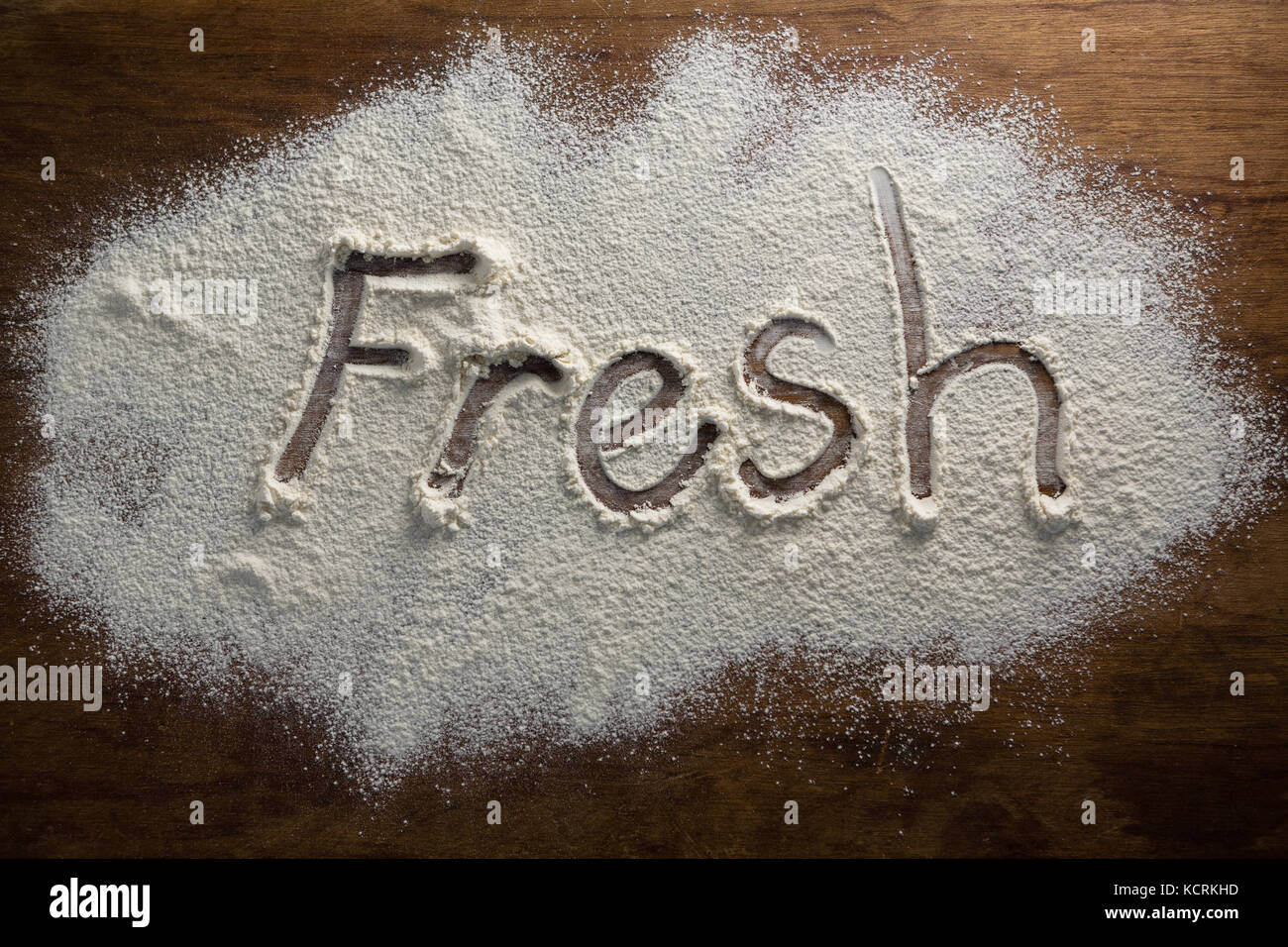 Over head view of the word fresh written on sprinkled flour Stock Photo ...