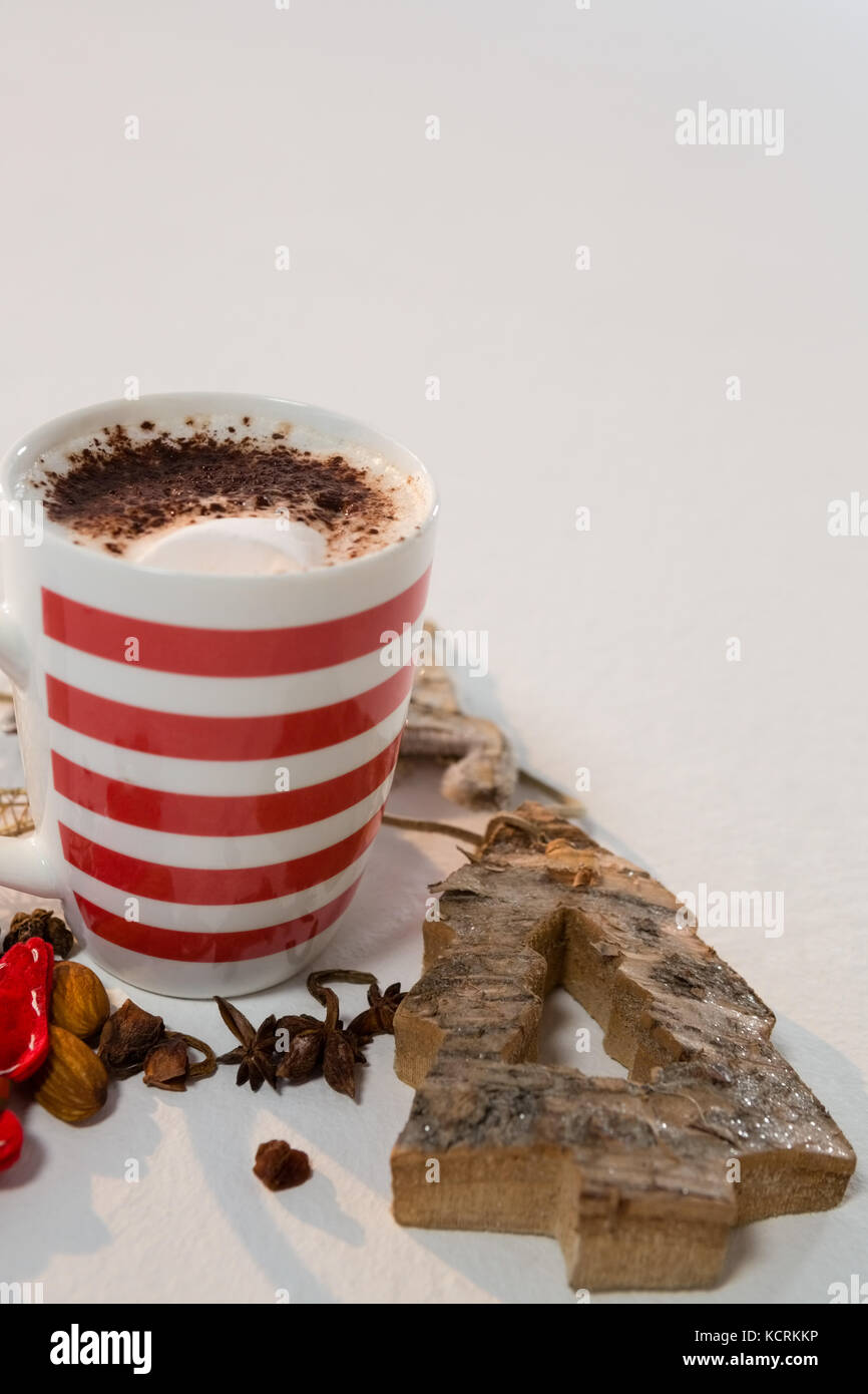 Coffee with cinnamon powder and christmas decorations on white ...